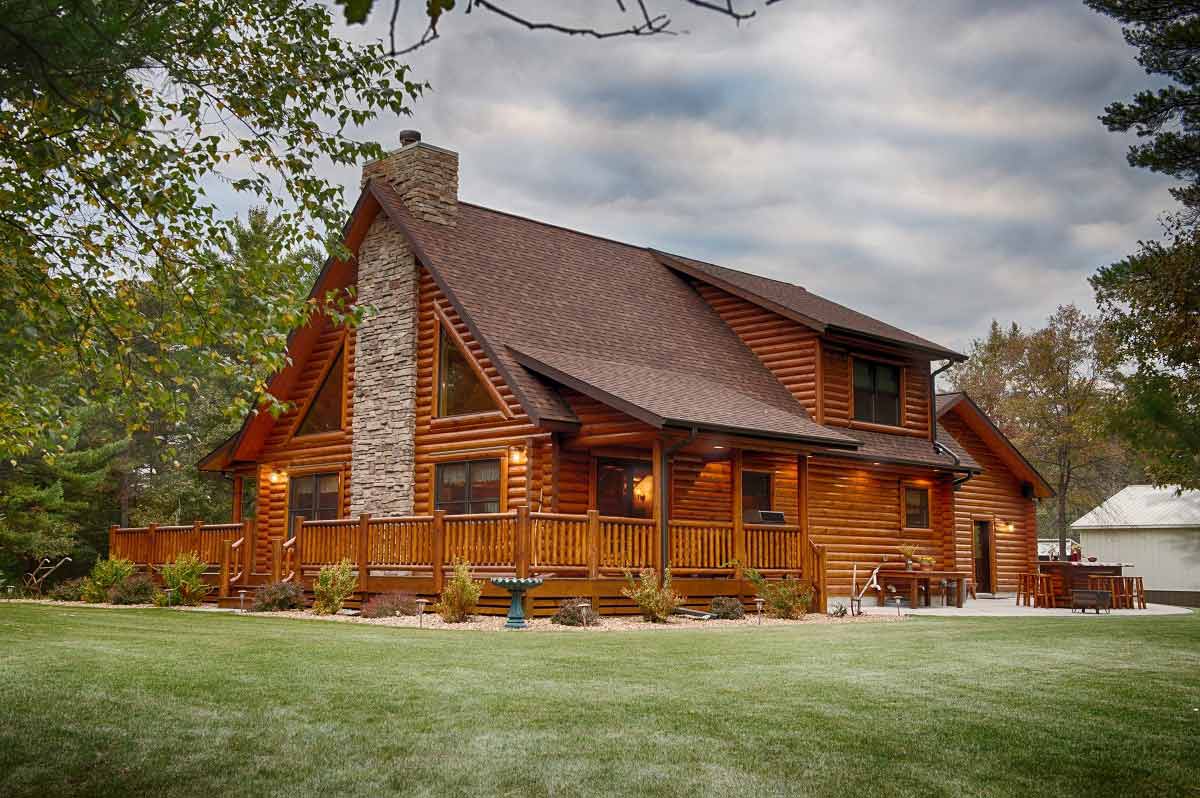 The Lofted Log Home Model Features an Attached Garage